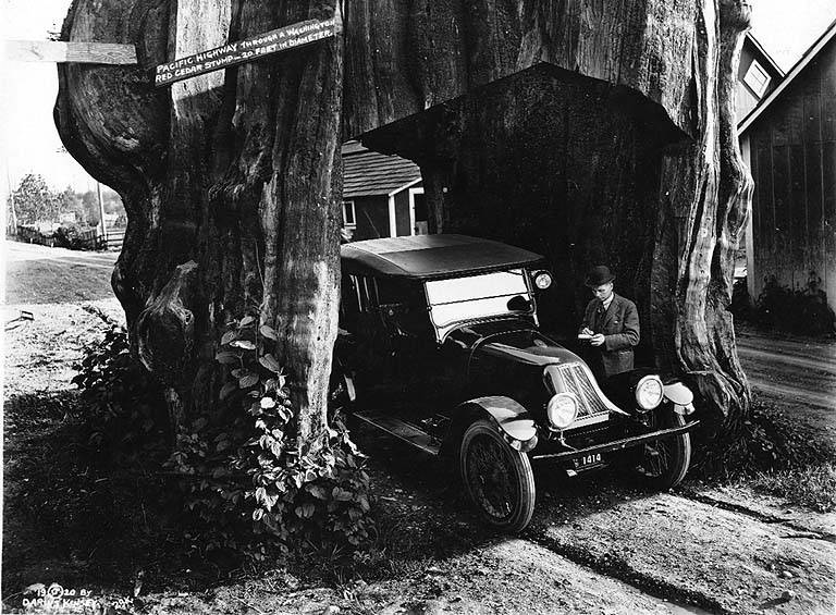 Early photography: Darius Kinsey and his automobile at an arch in a red ...